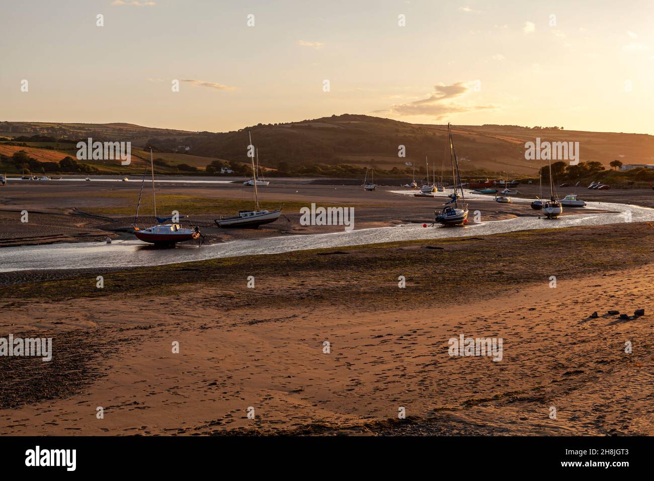 Boats lie marooned at low tide in the Teifi estuary,The Patch, Gwbert ...