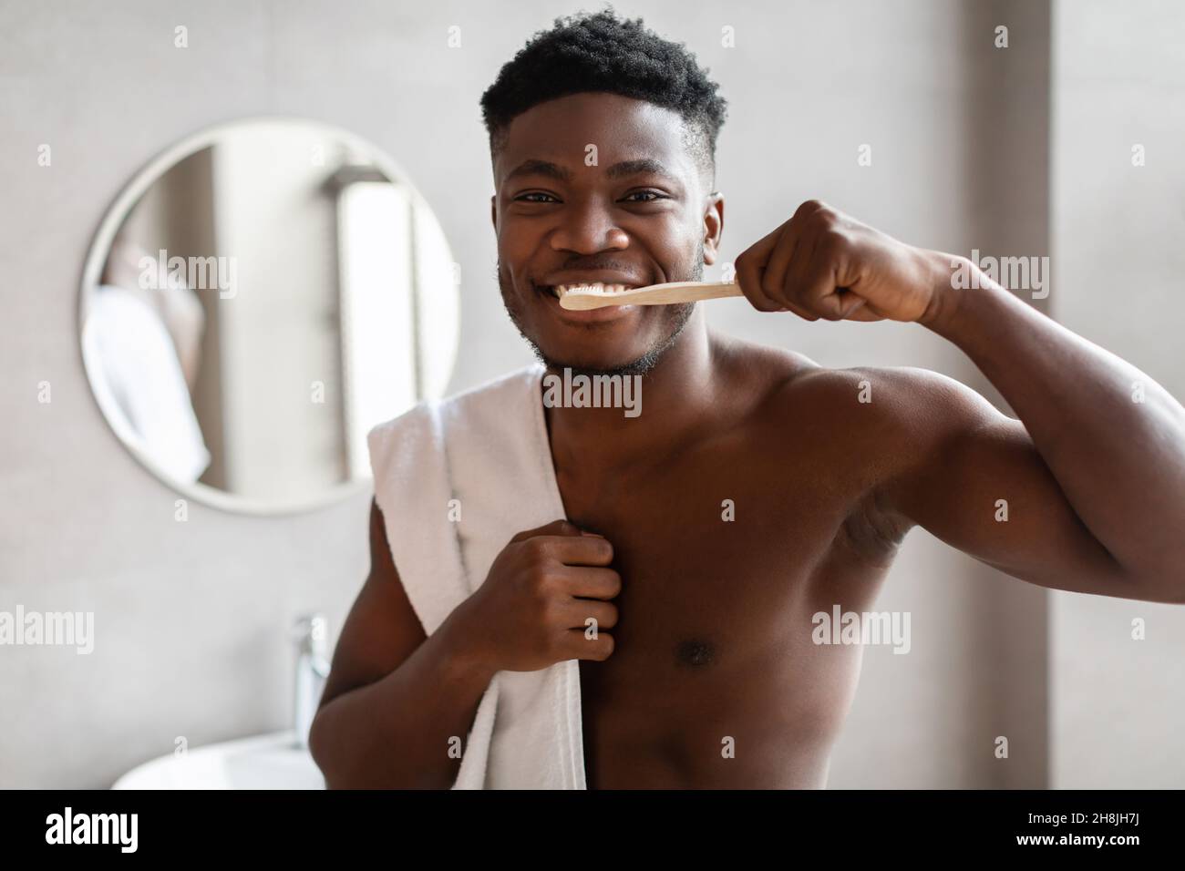 Happy African American Guy Cleaning Teeth In Modern Bathroom Stock ...