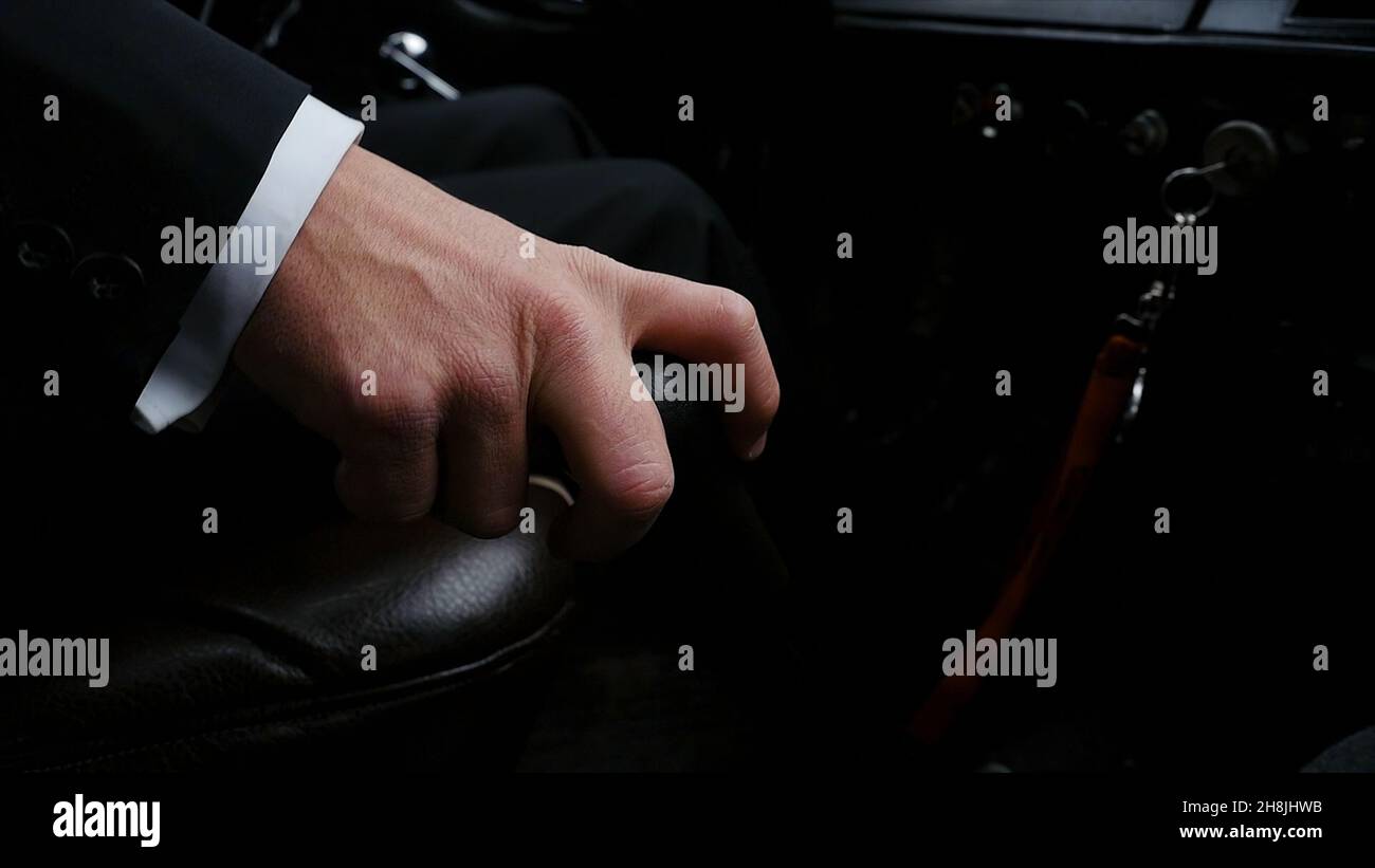 Businessman driving to work, hand shifting the gear stick. Businessman ...