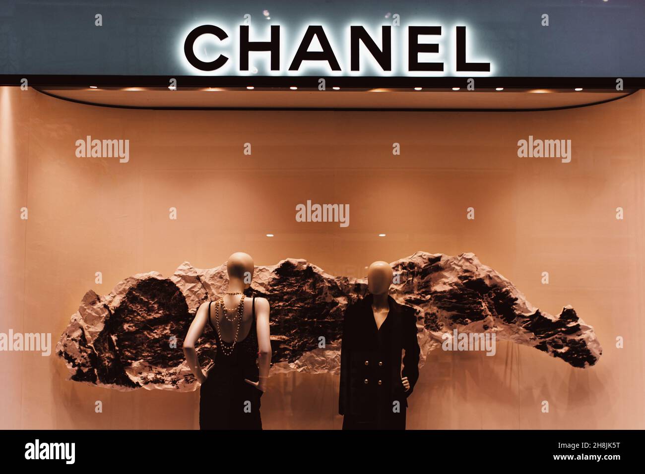 Chanel luxury shop in Moscow. Two mannequins dressed in elegant black ...