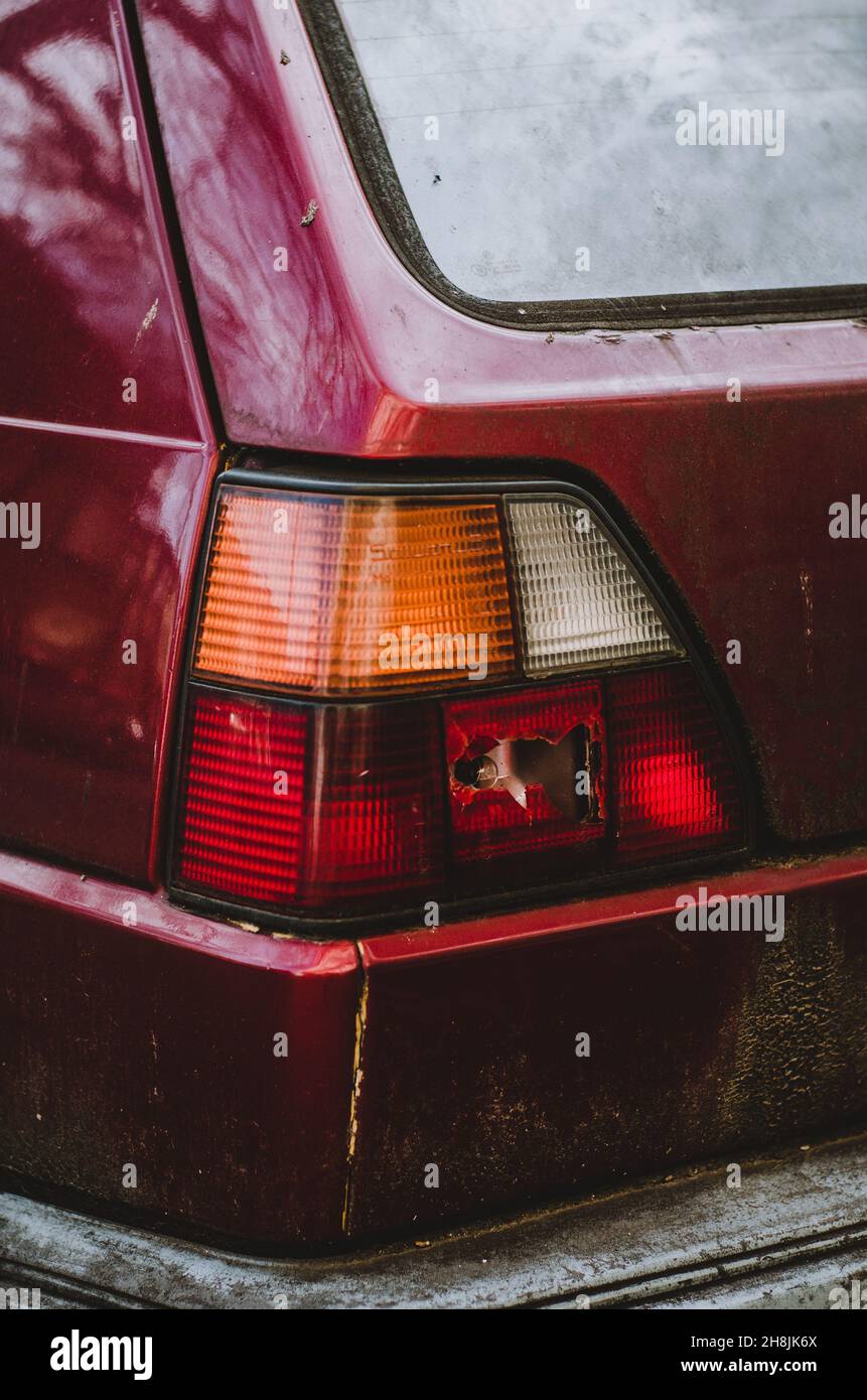 Vertical closeup shot of a dirty broken backlight of a red car Stock ...