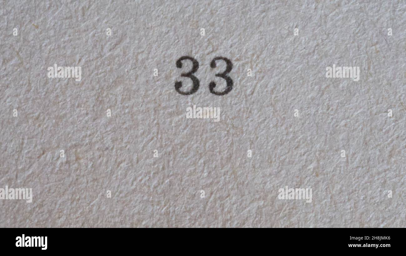 The number 33 printed on a piece of paper. Paper texture Stock Photo ...