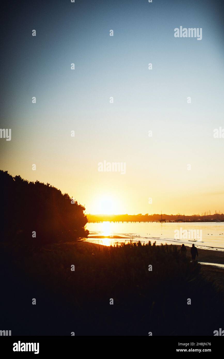 Sun setting/rising over ocean Stock Photo - Alamy