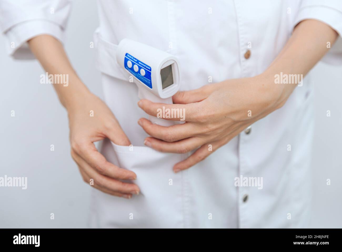 Temperature measurement gun in doctor hands. Close-up shot of doctor ...