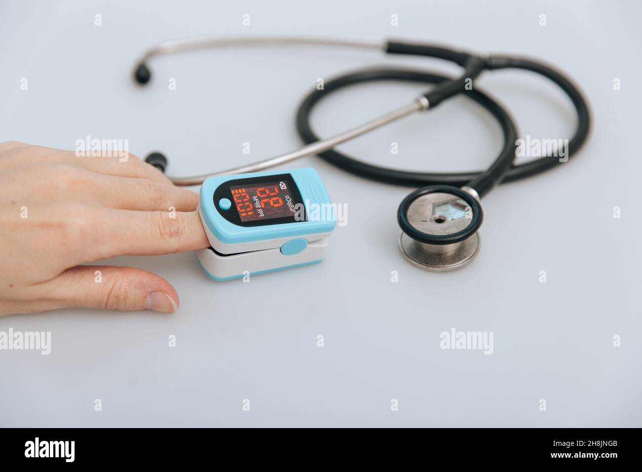 Stethoscope, pulse oximeter and thermometer gun on white background ...