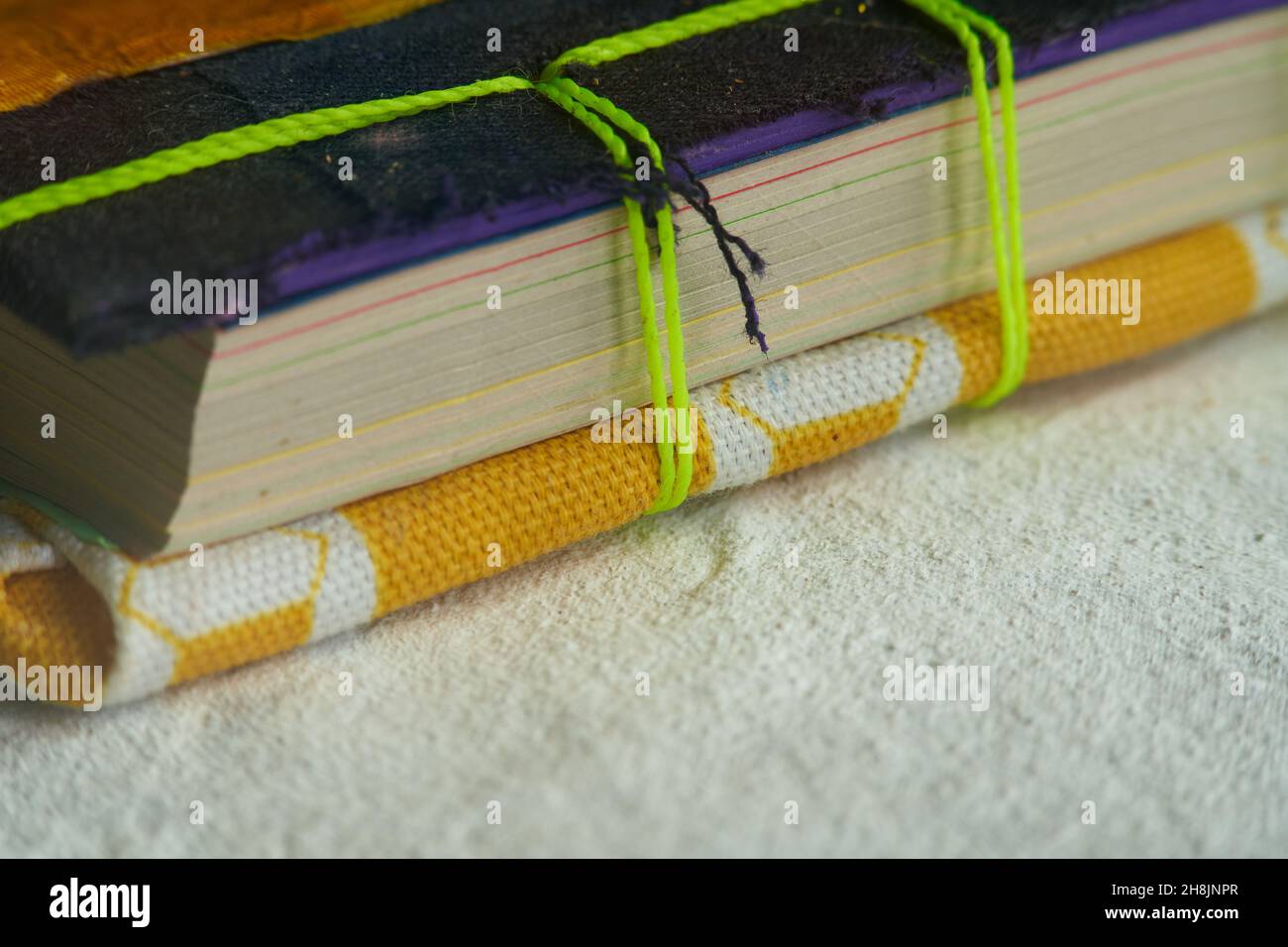 Closeup shot book cover with handmade green fabric thread binding ...