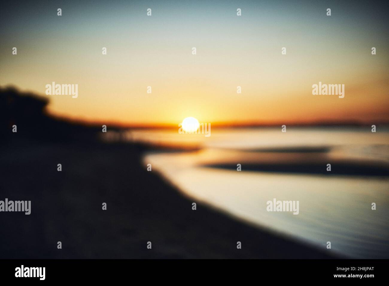 Sun setting/rising over ocean Stock Photo - Alamy
