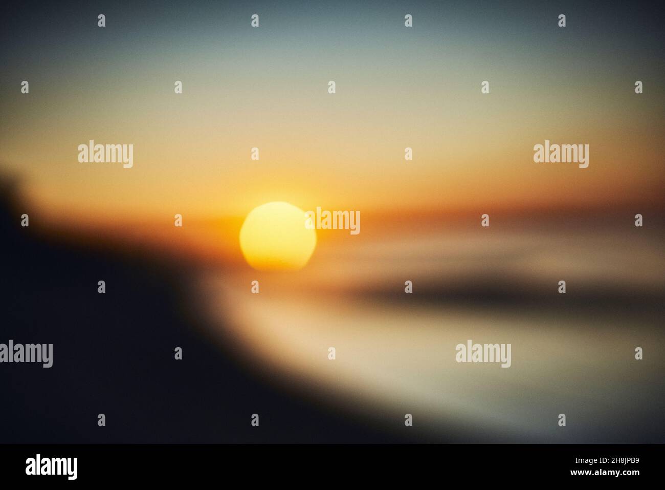 Sun setting/rising over ocean Stock Photo - Alamy
