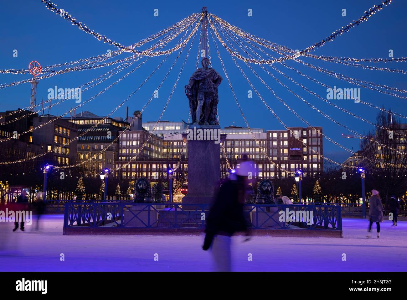 Winter in Stockholm. Ice skating in the square in Kungstradgarden ...