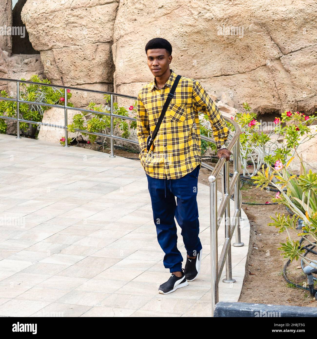 An African Tourist posing for a photo Stock Photo - Alamy