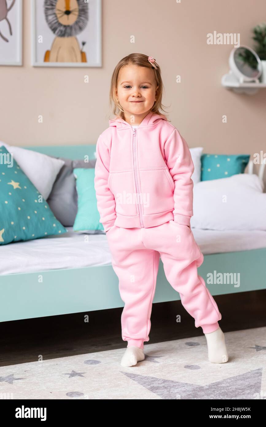 Cute little girl posing in a costume in her room. Little fashion model ...