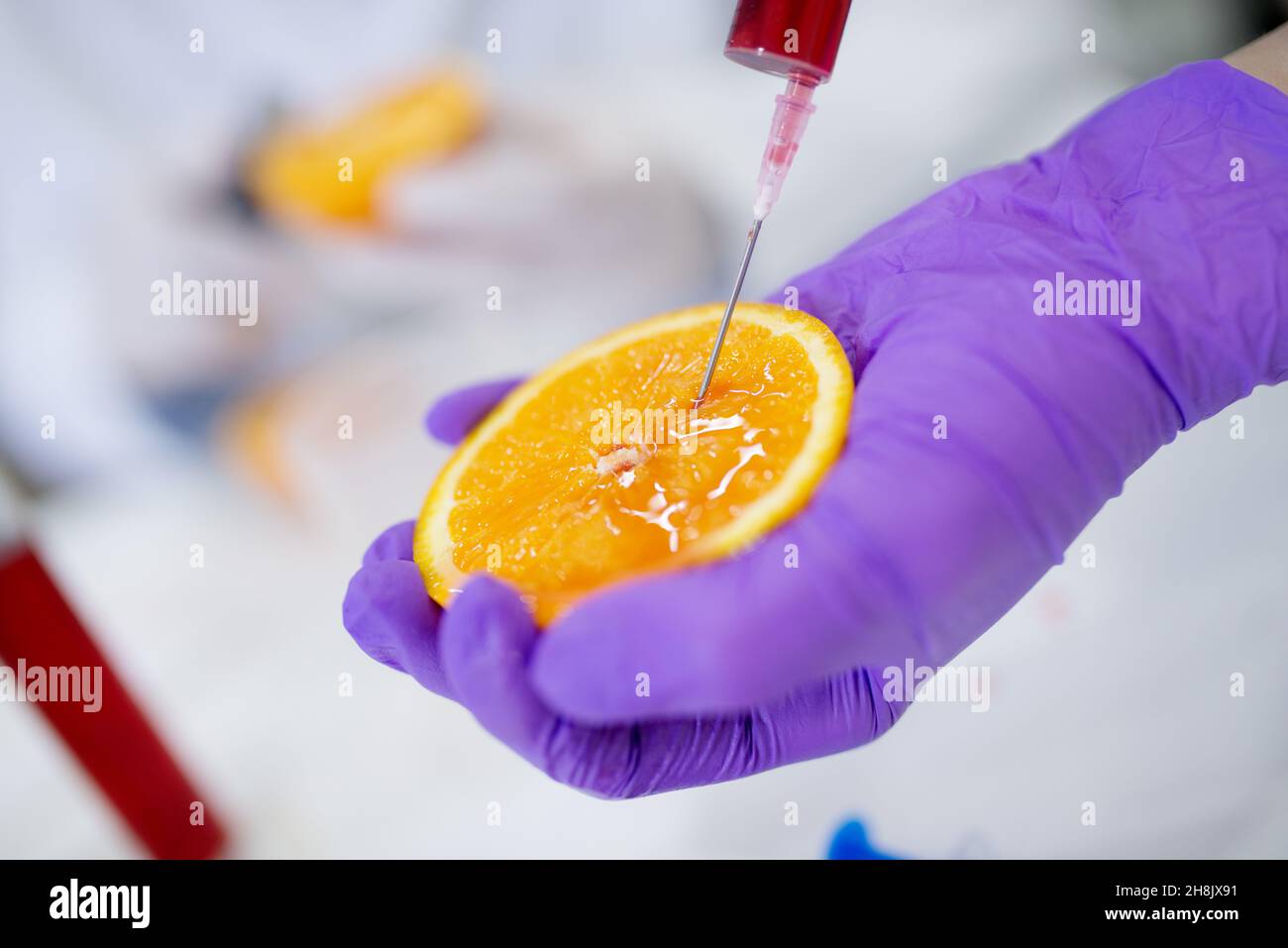 Syringe injecting orange fruit hi-res stock photography and images - Alamy
