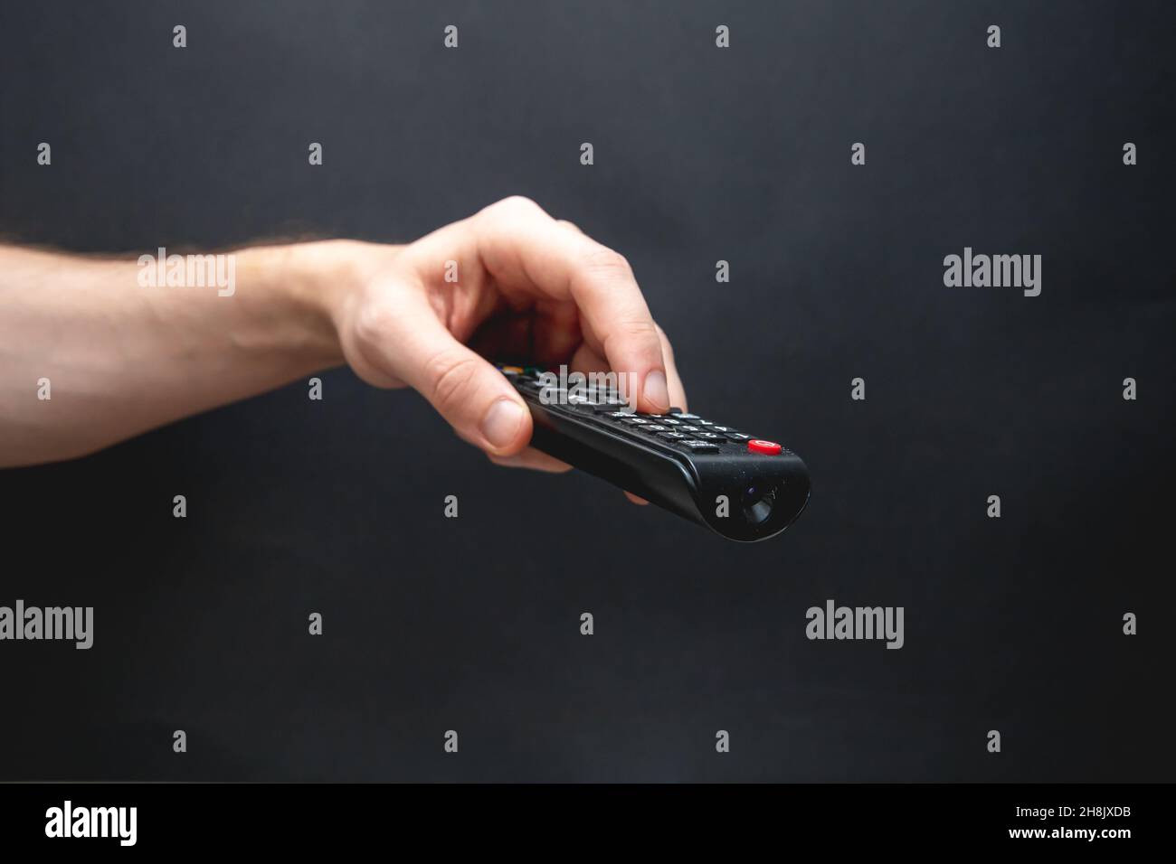 Hand holding a remote control in the black background Stock Photo - Alamy