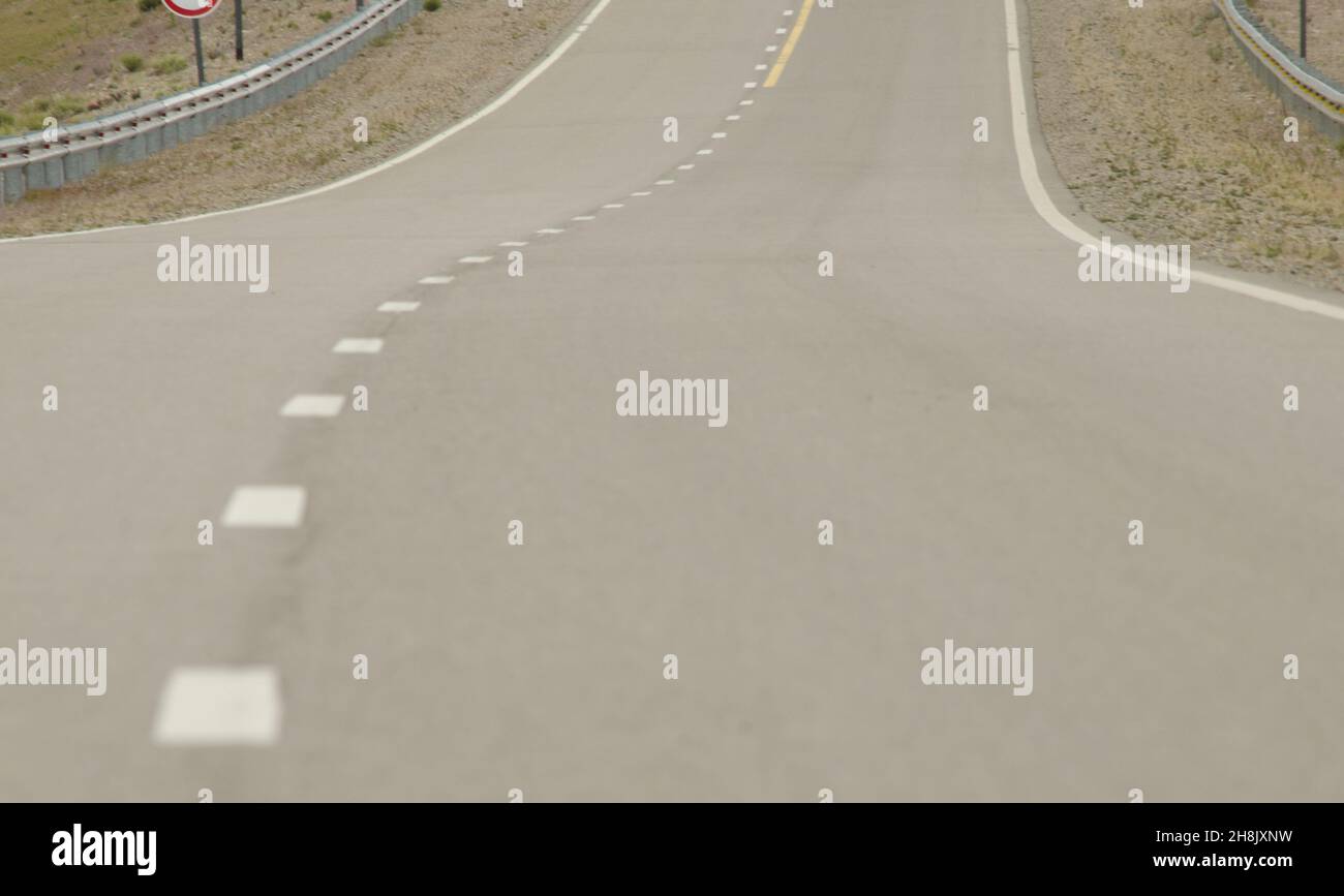Closeup view of an asphalt high road with a pattern white signs Stock ...