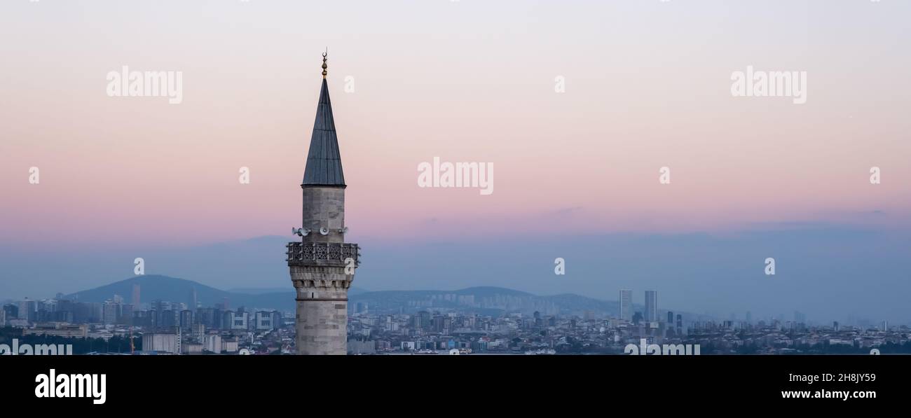 Minaret in front of a sunset background Stock Photo - Alamy