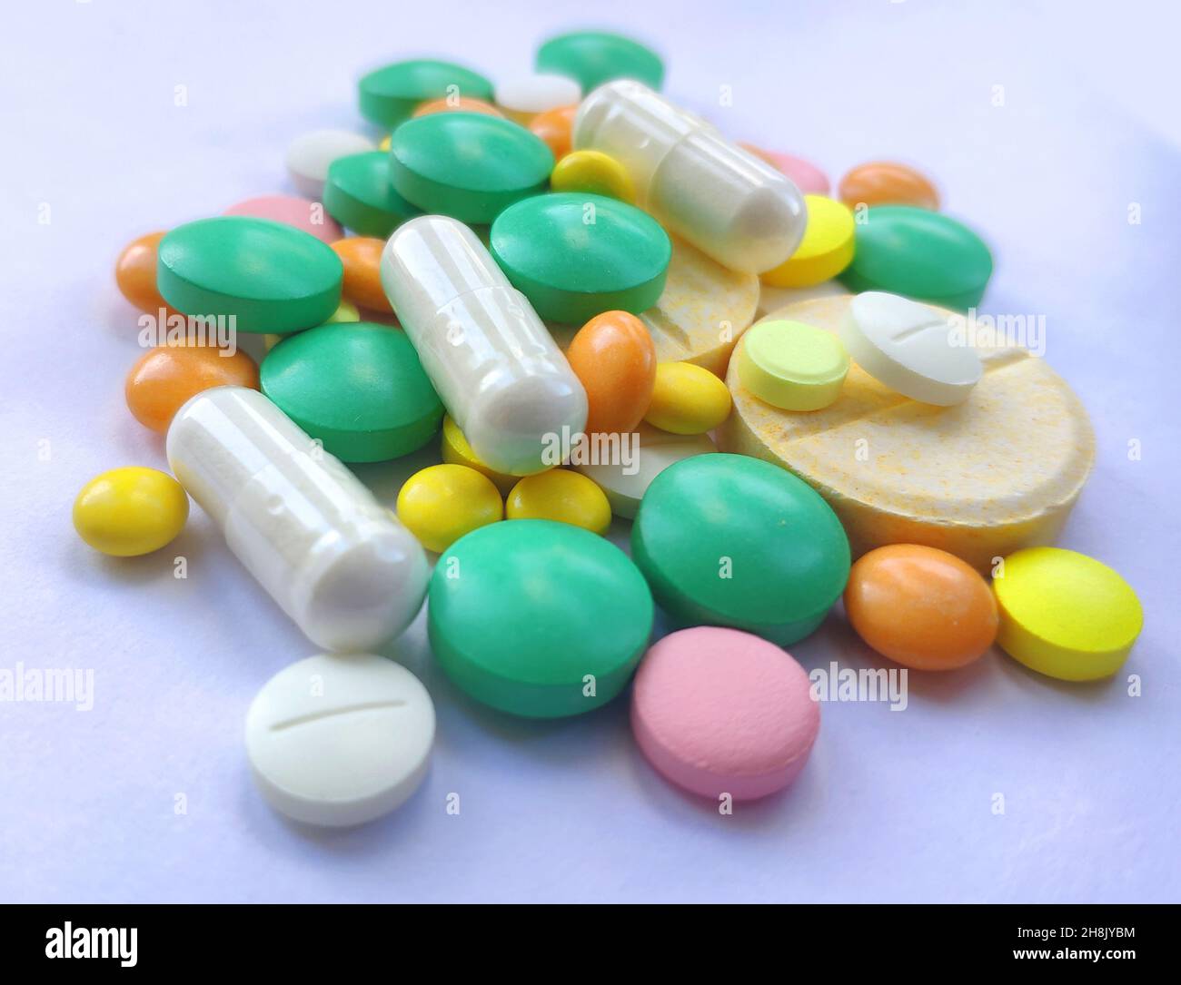 Stack of colorful pills, medicine background. Tablets prescribed for ...