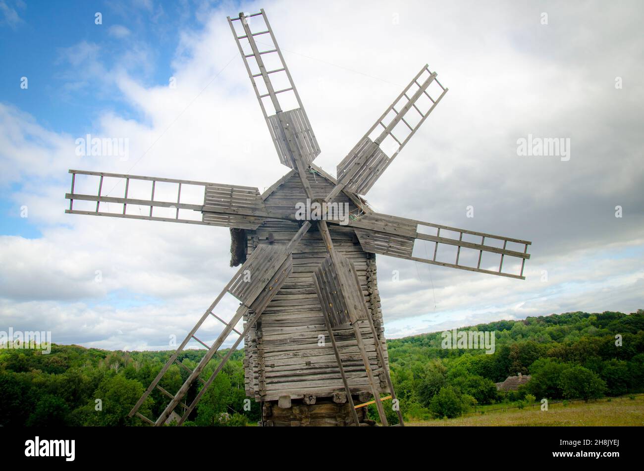 Wooden windmill in the forest, summertime folklore background Stock ...