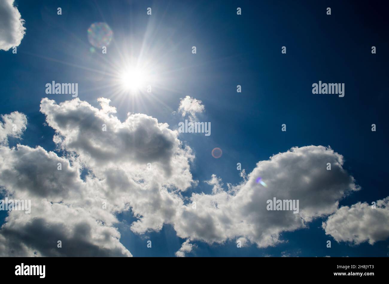 Blue sky with white clouds in sun rays, pure sky background Stock Photo ...