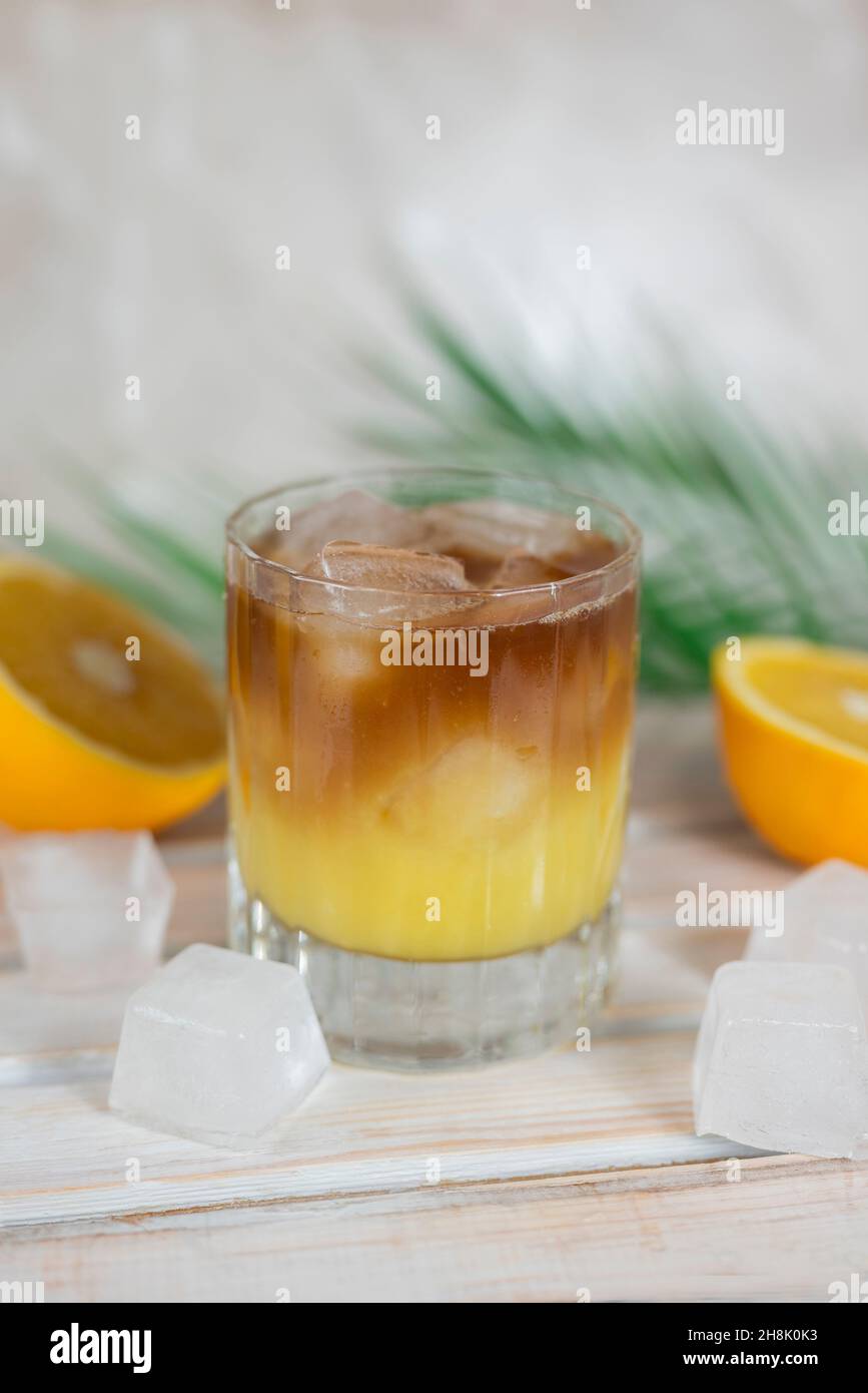 drink bumblebee bumble in a glass. Coffee with orange juice with ice ...