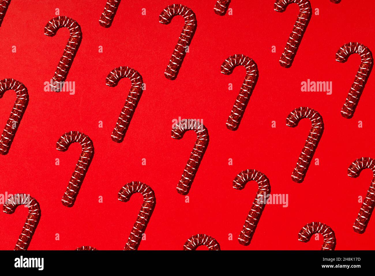 Christmas holiday pattern. Red canes on red background Stock Photo - Alamy