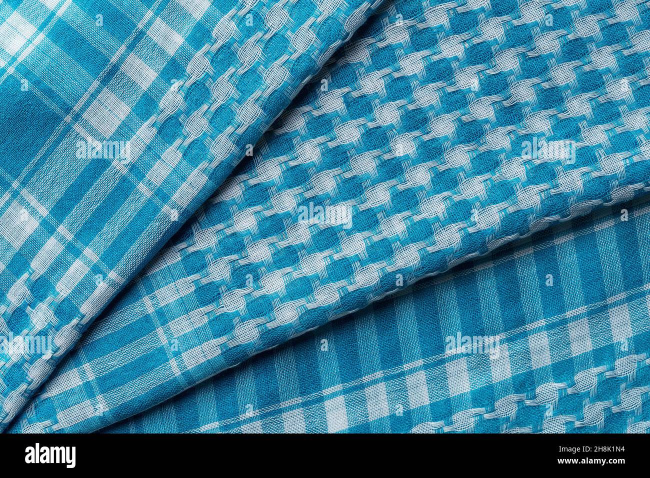 Folded keffiyeh of azure white colors background. Draped cotton shemagh ...