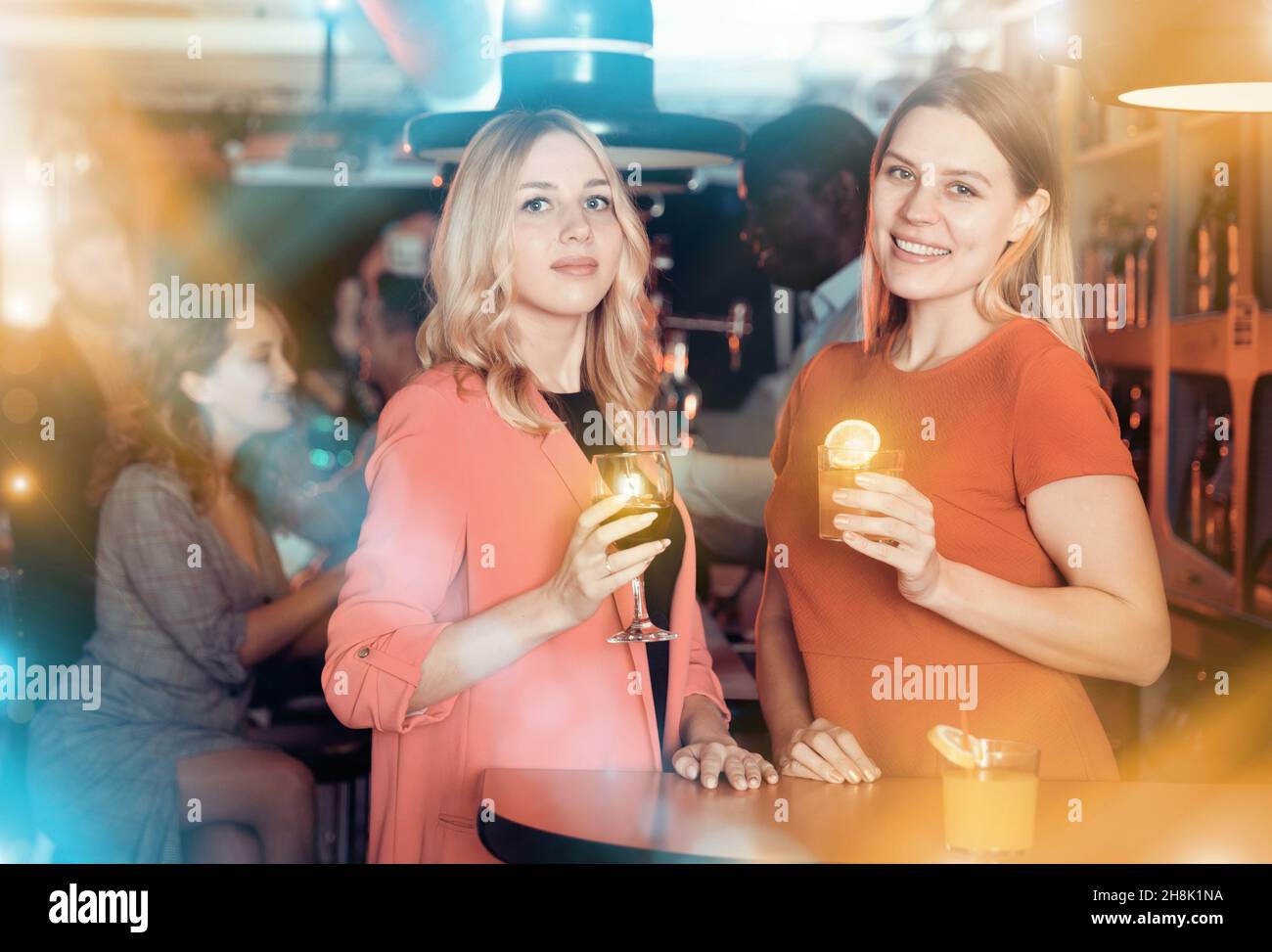Two young women with cocktails having fun on party at nightclub Stock ...