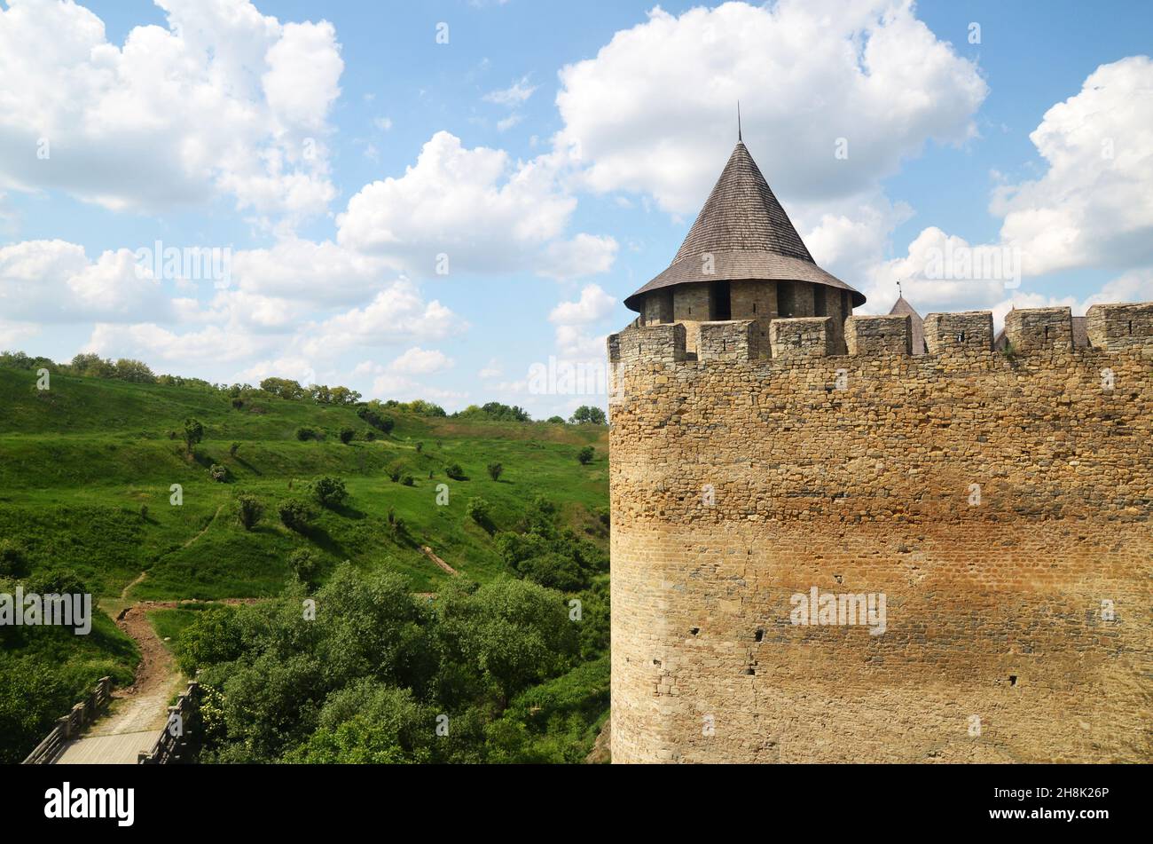 Medieval castle standing over a green summer field Stock Photo - Alamy