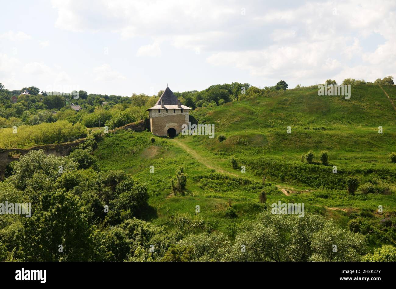 Medieval landscape with ruins of old fortress walls and a tower. The ...
