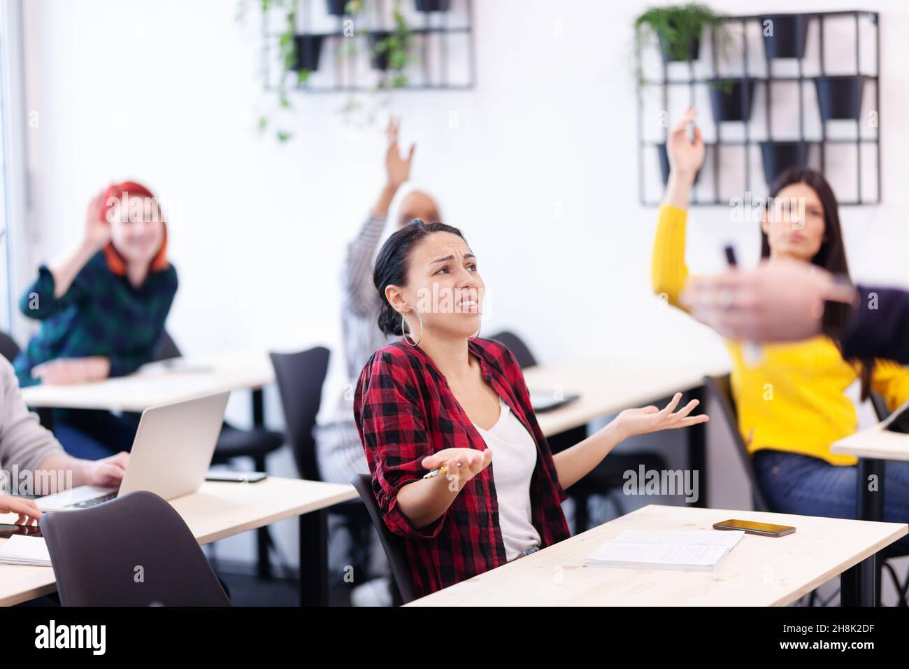 Multi ethnic students listening to a lecturer in a classroom. Smart ...