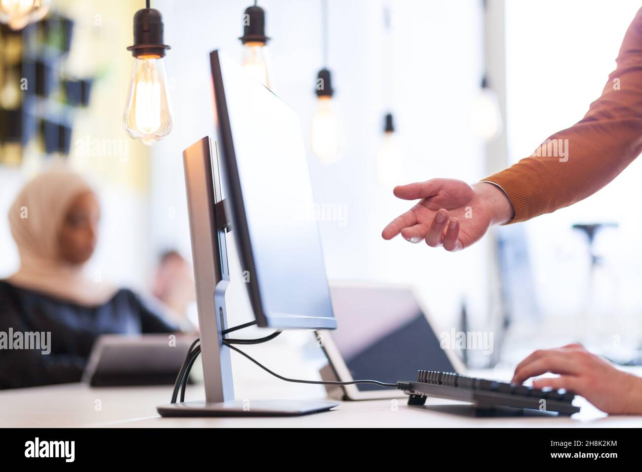 Business people having conversation in modern coworking office space ...