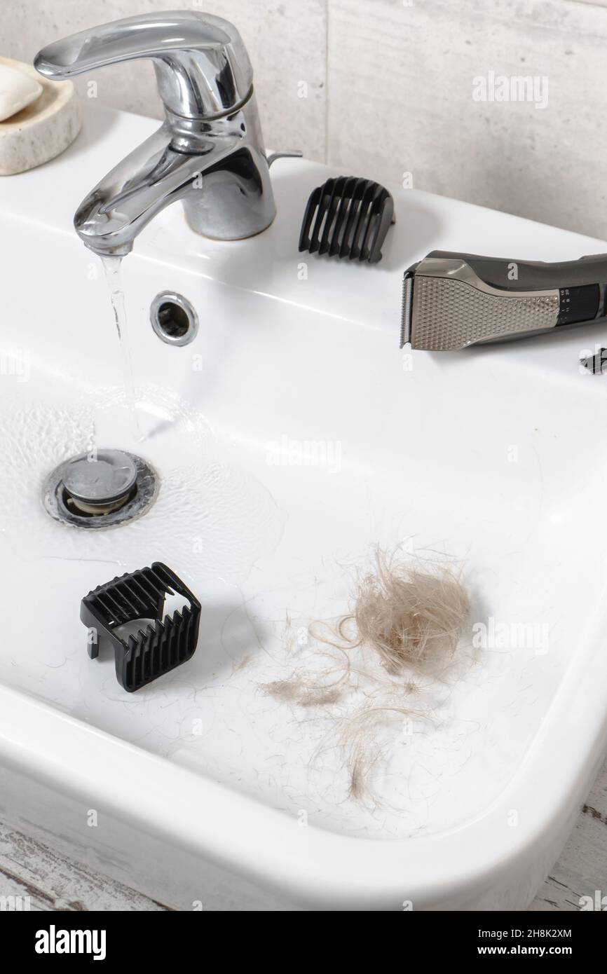 Cleaning electronic shaving razor in sink, male self care and personal ...