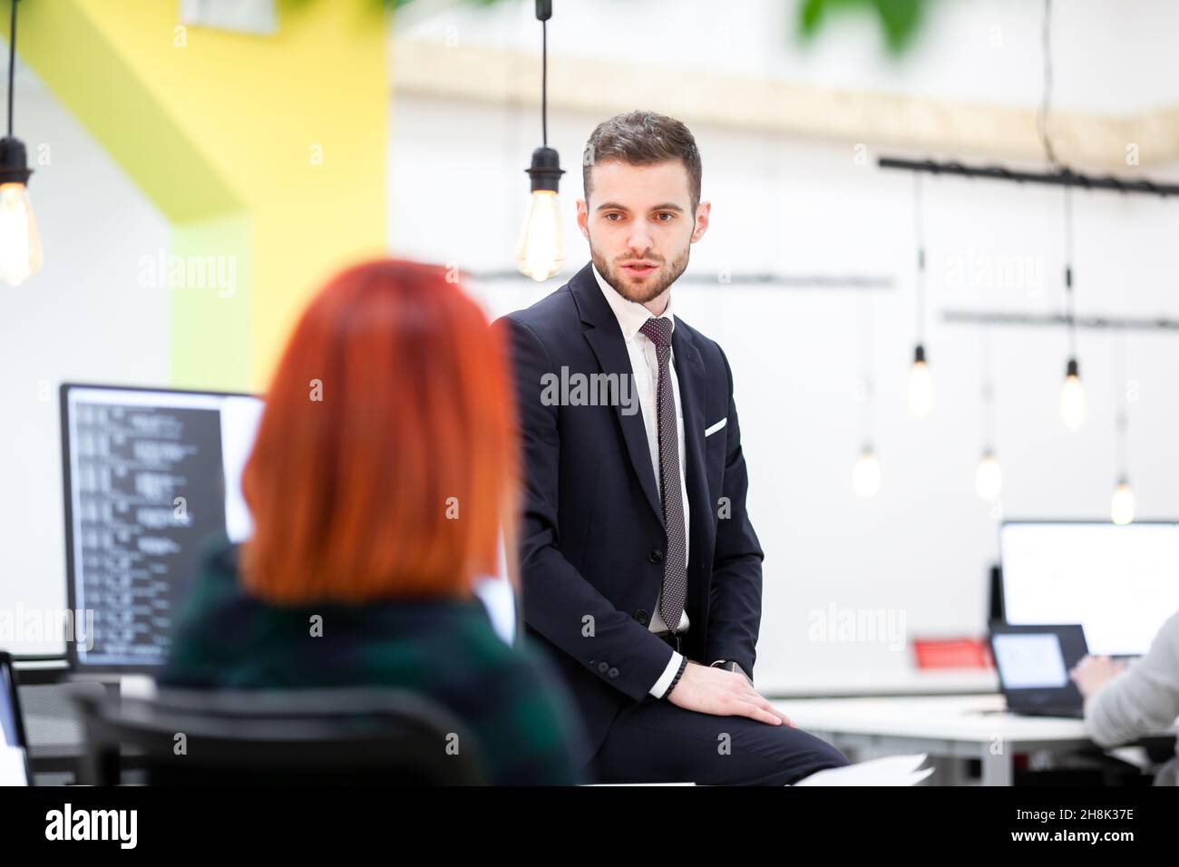 Business people having conversation in a modern coworking office space ...