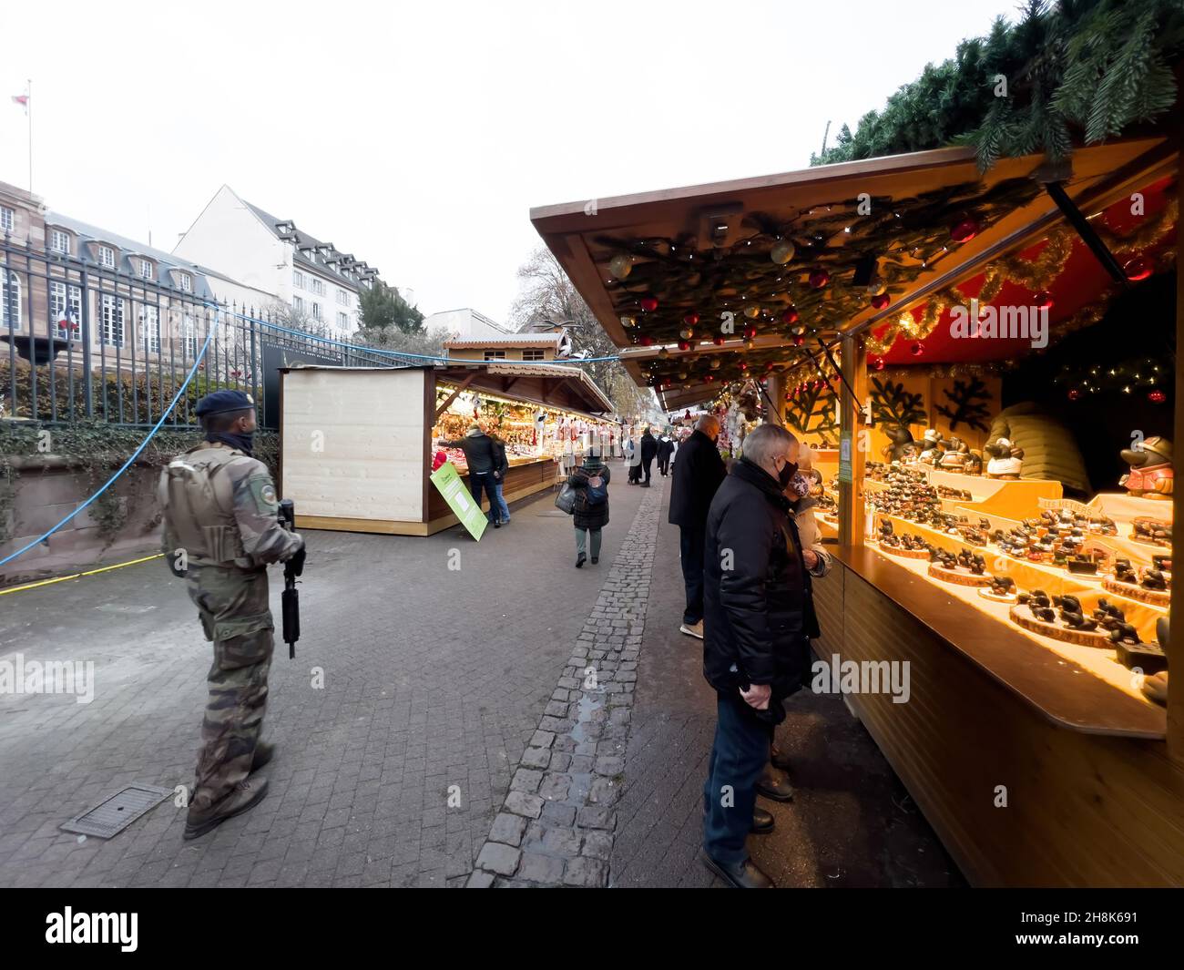 Armed personell with rifles surveillance people wearing safety ...