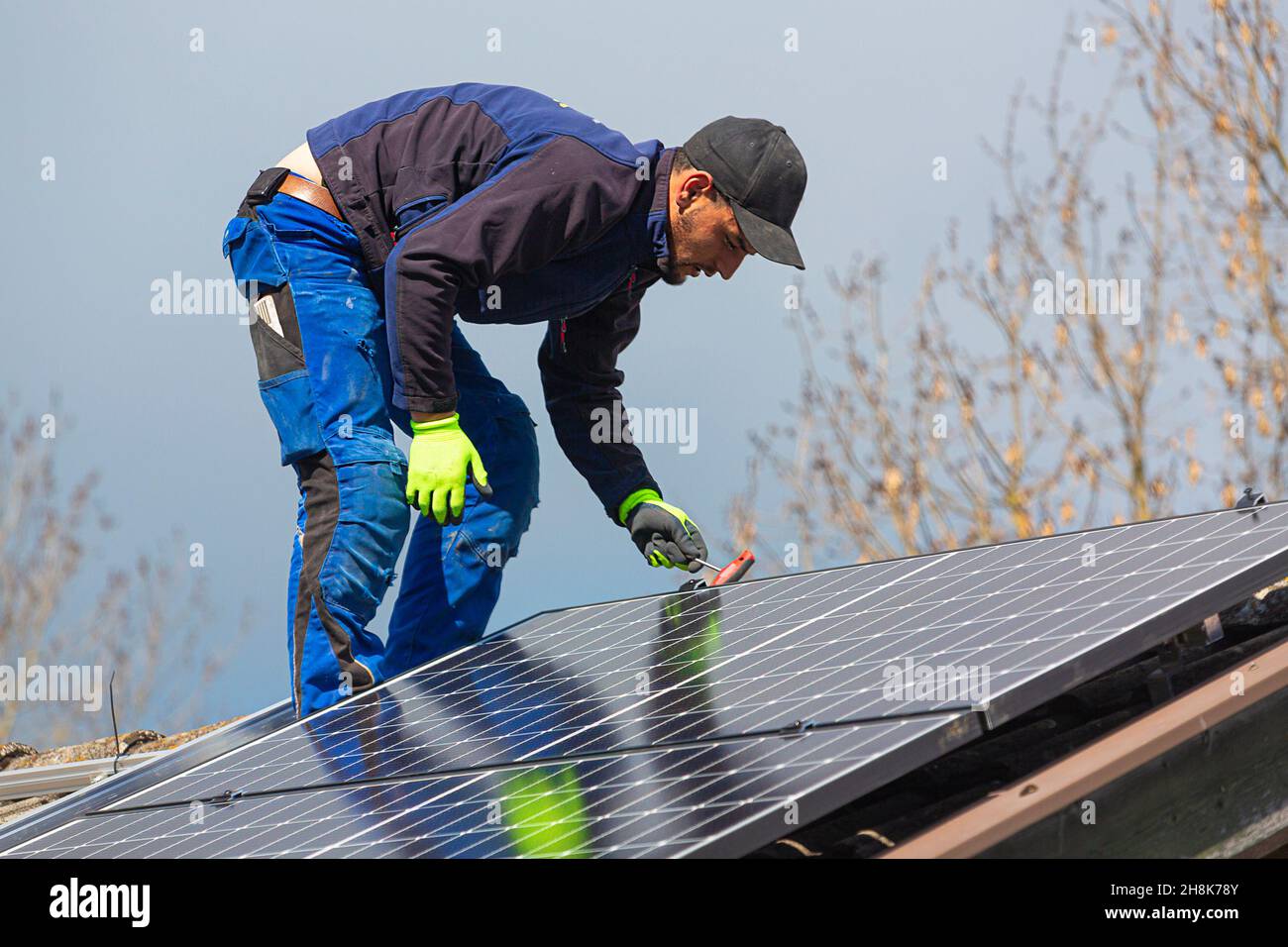 Installing solar photovoltaic panel system. Solar panel technician ...