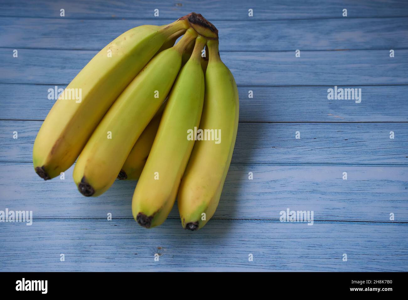yellow bananas on blue countertop. fresh fruit from the market Stock ...