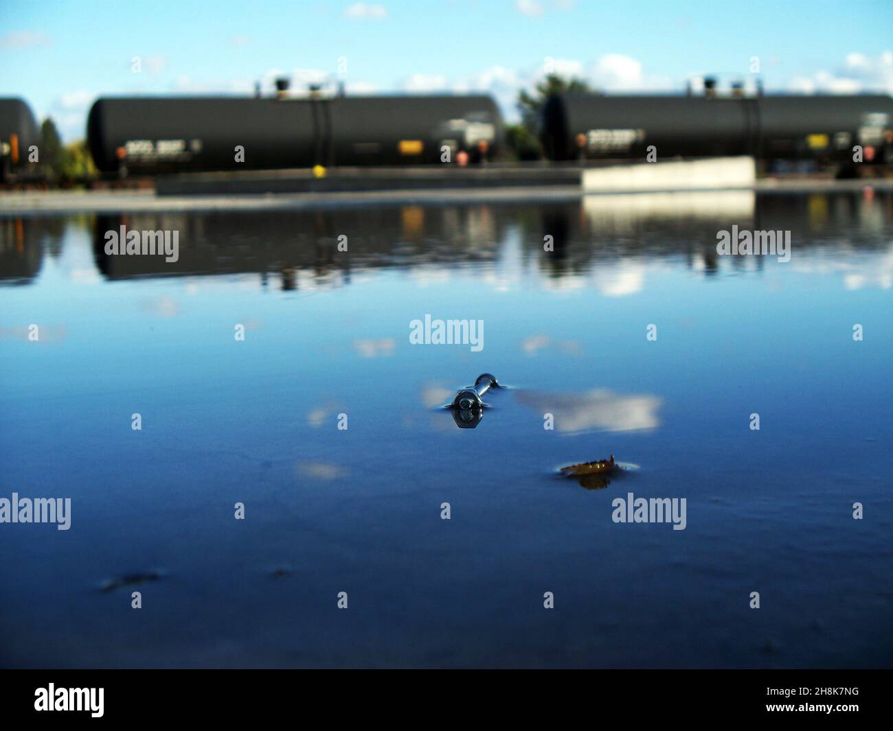 Train reflected in a puddle of water Stock Photo - Alamy