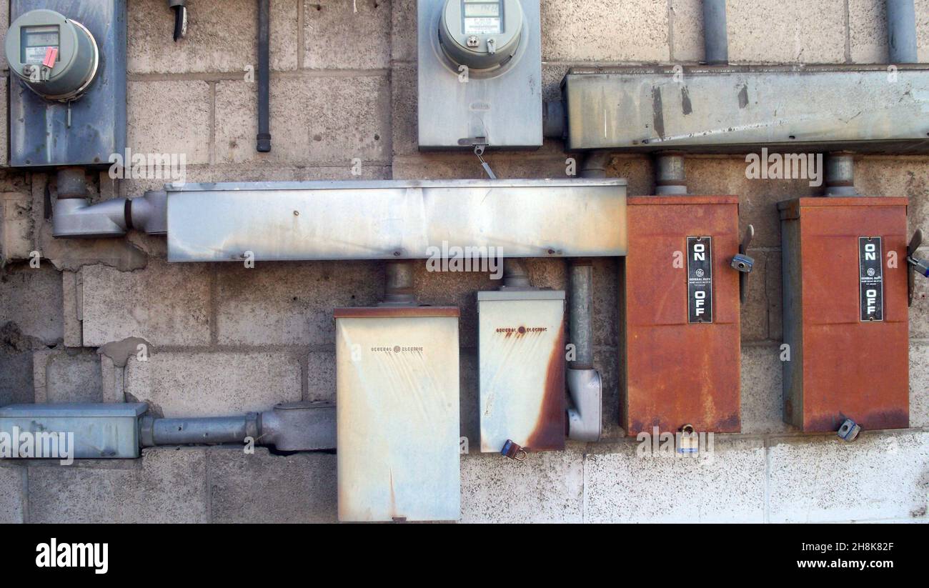 Photo of old electrical boxes on the side of a residential building ...