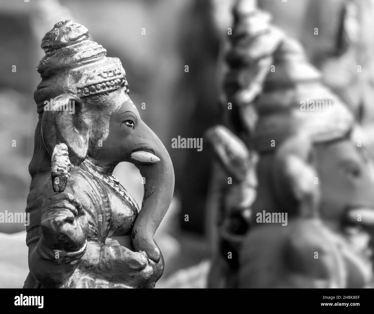 Grayscale shot of the Ganesha sculpture in the Indian souvenir shop ...