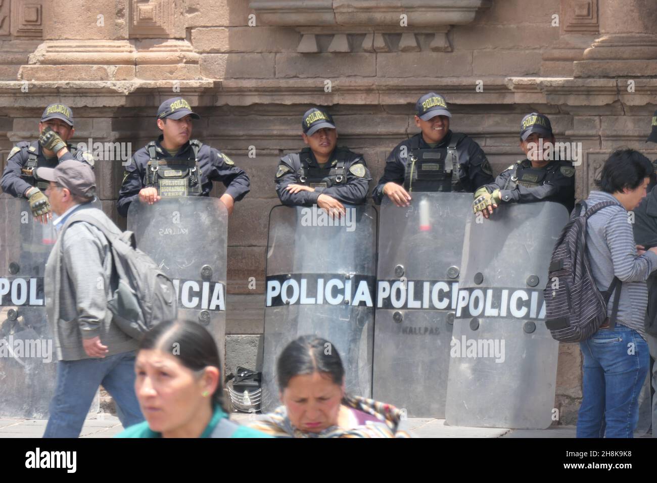 Peru riot police with shields in street at Carnival Cusco smiling ...