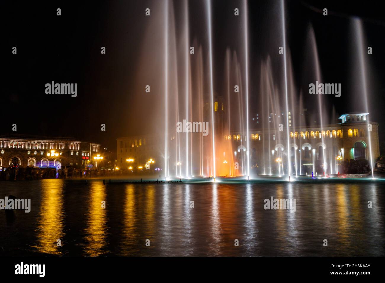 Beautiful illuminated fountains and buildings in the Republic Square at ...