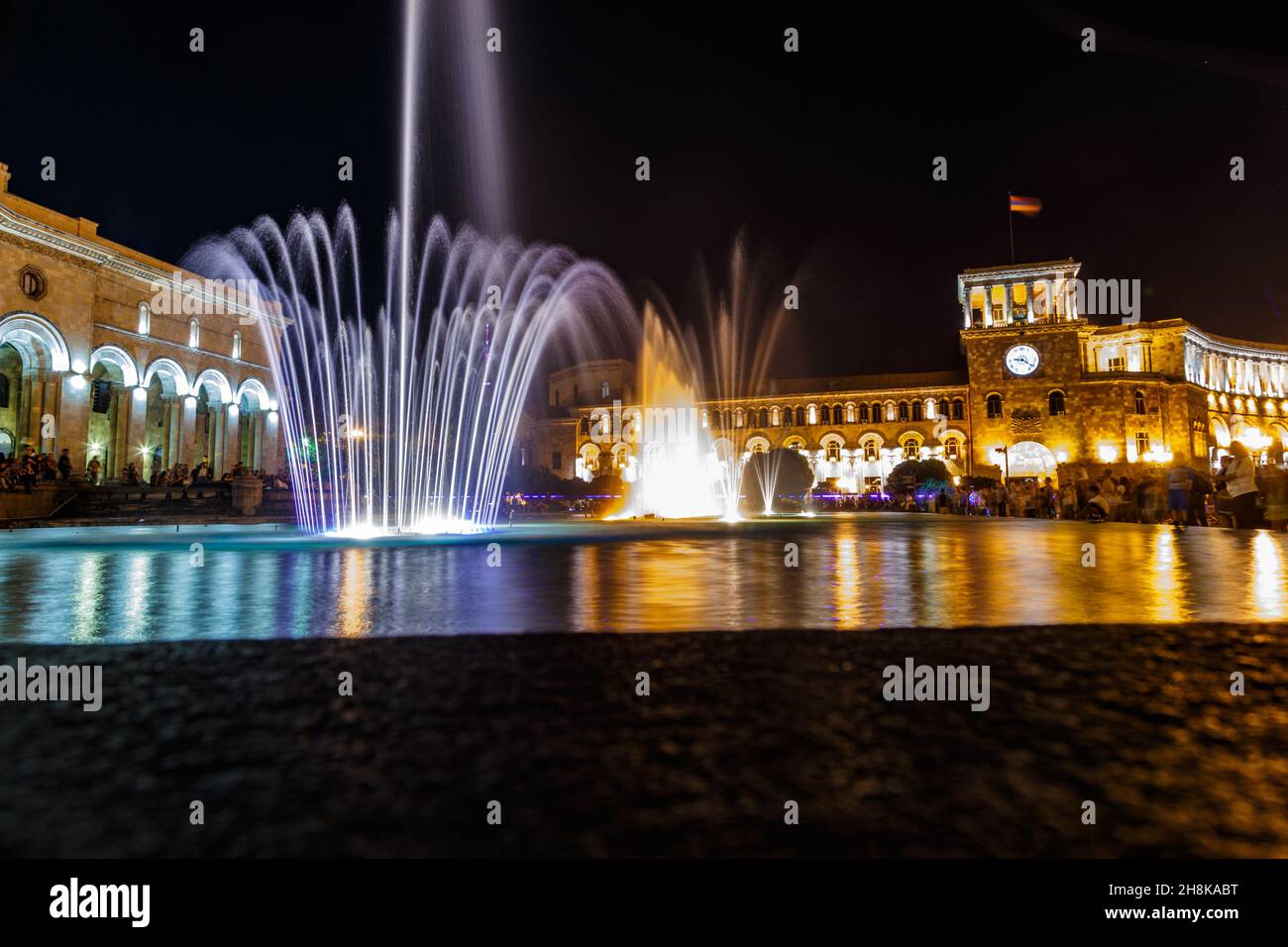 Beautiful illuminated fountains and buildings in the Republic Square at ...