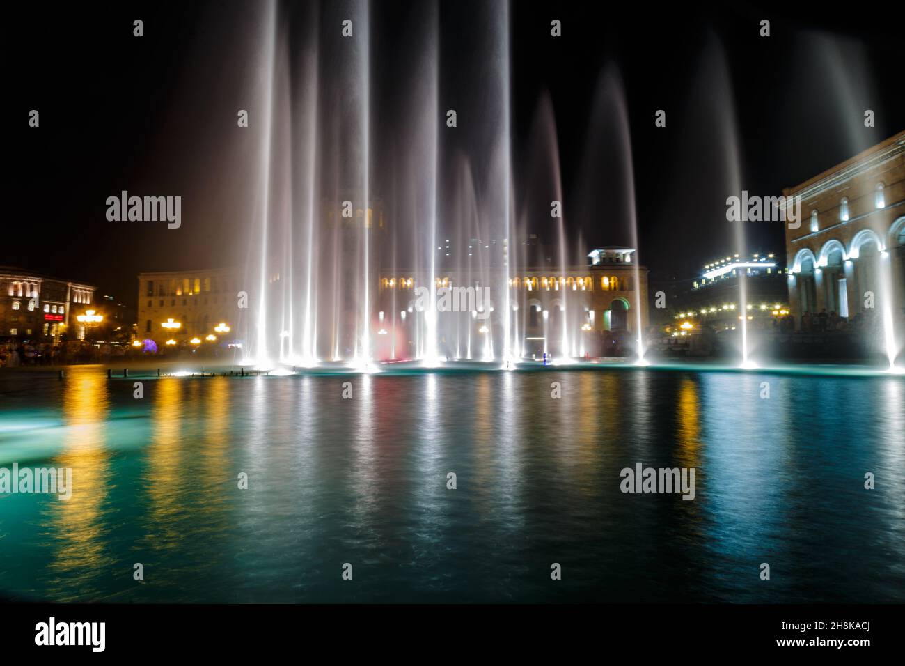 Beautiful illuminated fountains and buildings in the Republic Square at ...