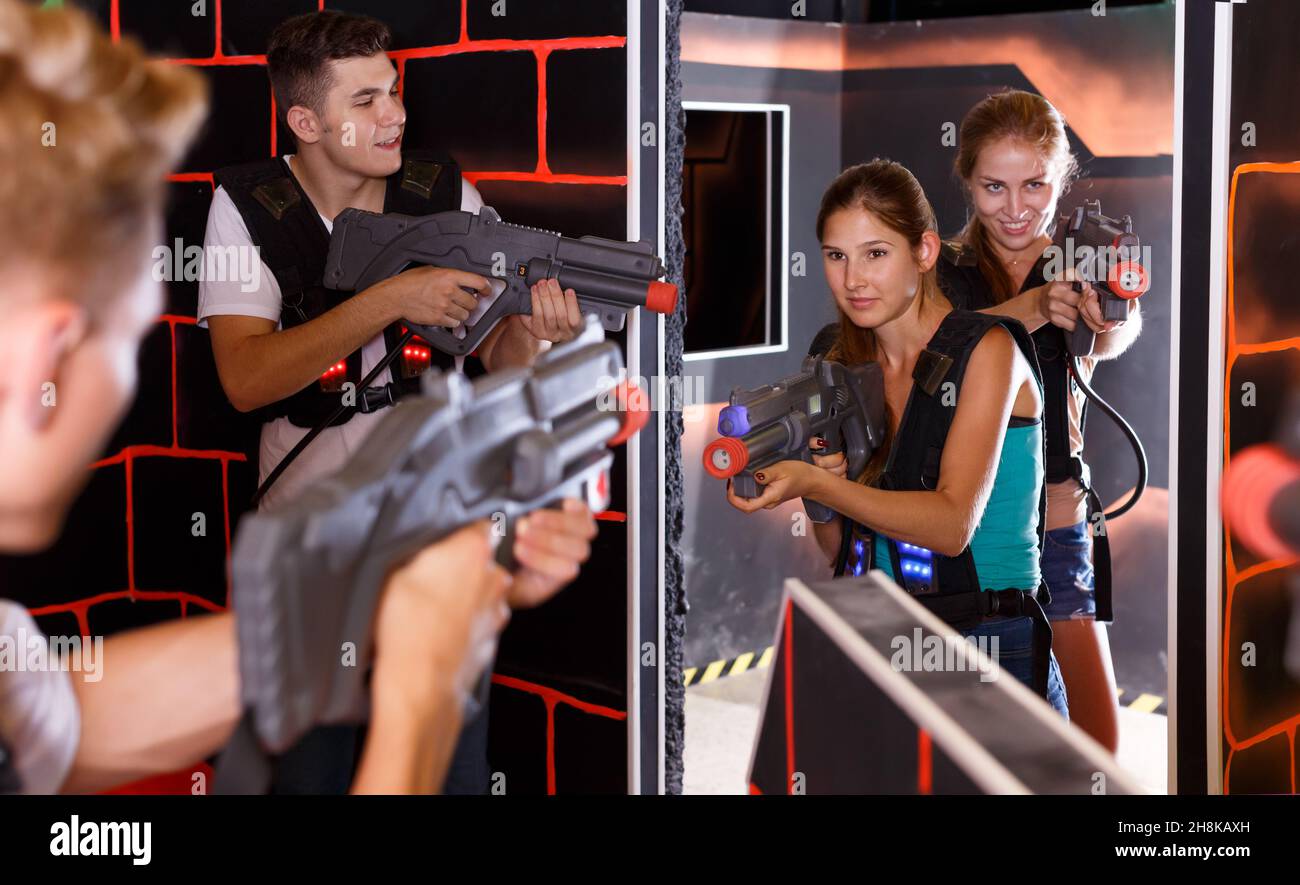 Friendly Laser tag players playing in teams Stock Photo - Alamy