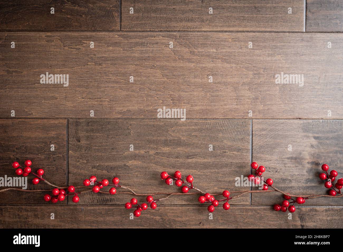 Border of vibrant red holly berries on dark wood with copy space Stock ...