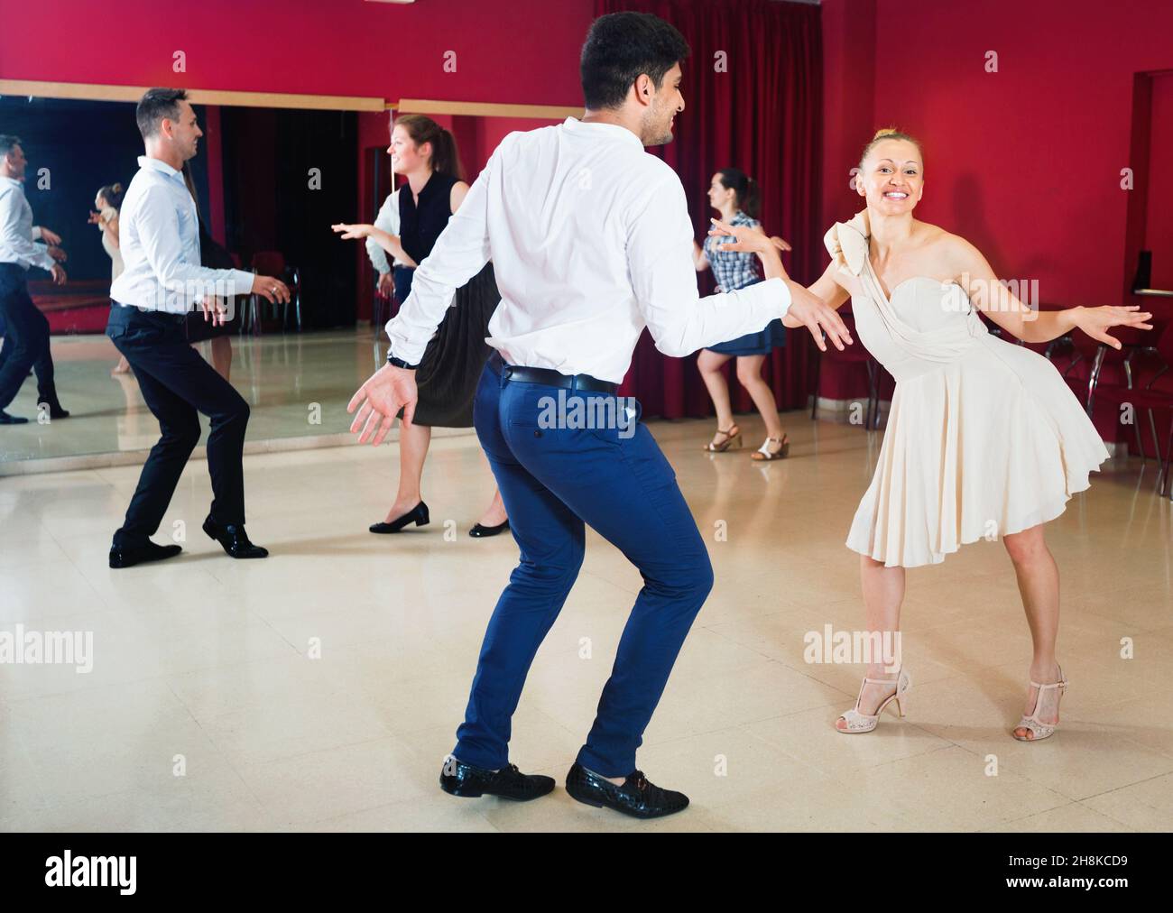 Positive people dancing twist in pairs Stock Photo - Alamy
