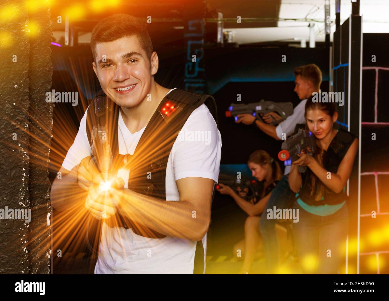 guy holding laser pistol playing laser tag game Stock Photo - Alamy