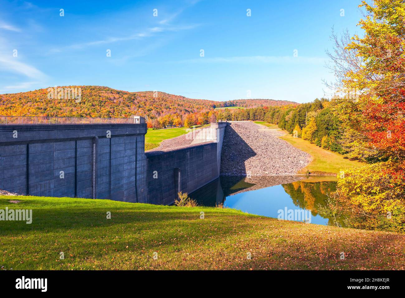 View of East Sidney Dam and the surrounding colorful forest in autumn ...