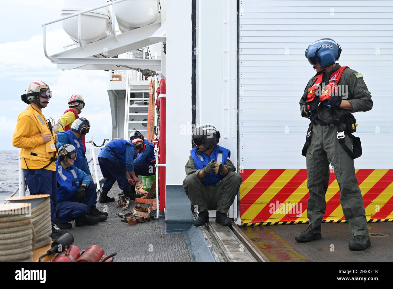 Crew of the USCGC Thetis (WMEC 910) converse with aircrew from several ...