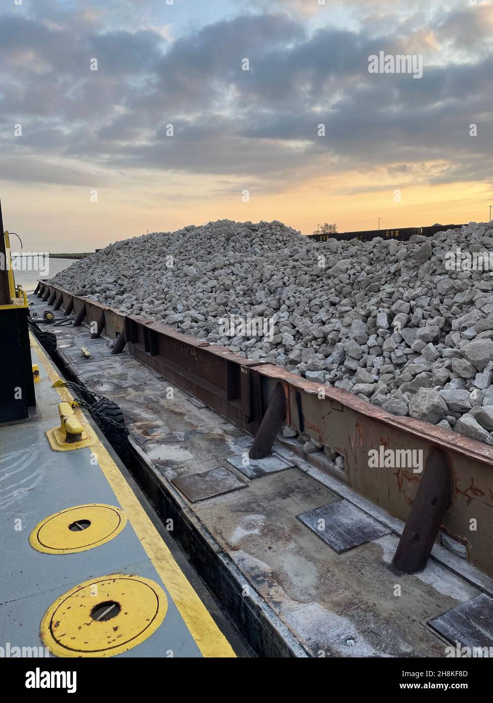 Stone sits on a barge, waiting to be placed in the Ashtabula Harbor as ...