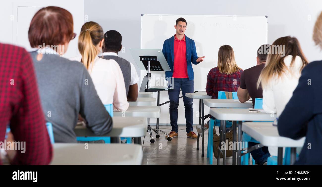 Male teacher lecturing to students Stock Photo - Alamy